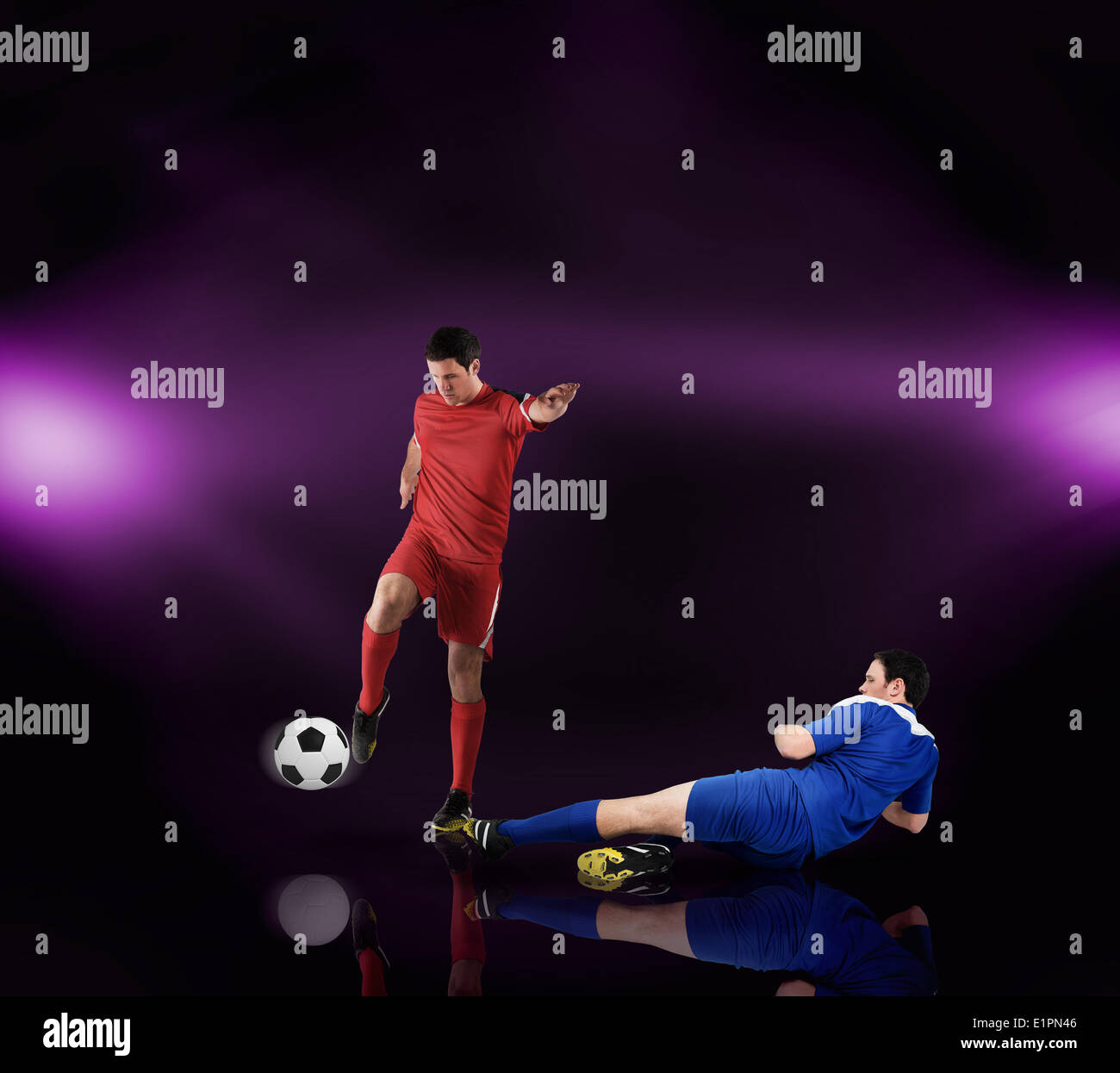 Football players tackling for the ball Stock Photo - Alamy