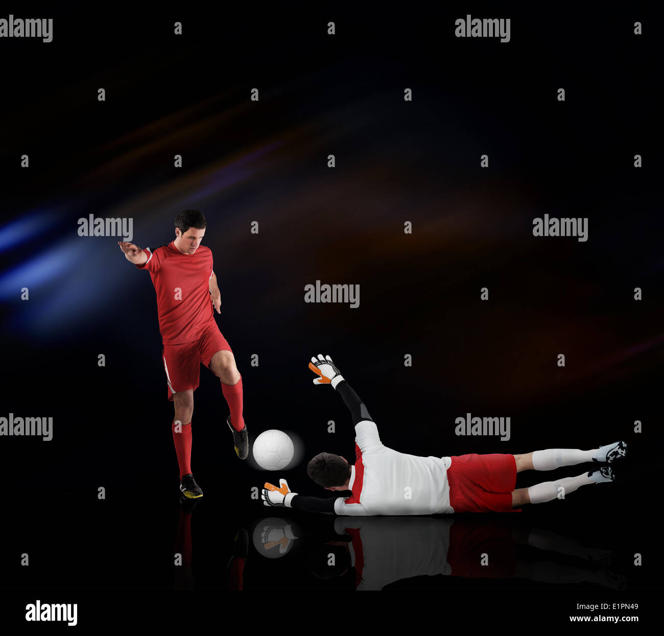 Football players tackling for the ball Stock Photo - Alamy