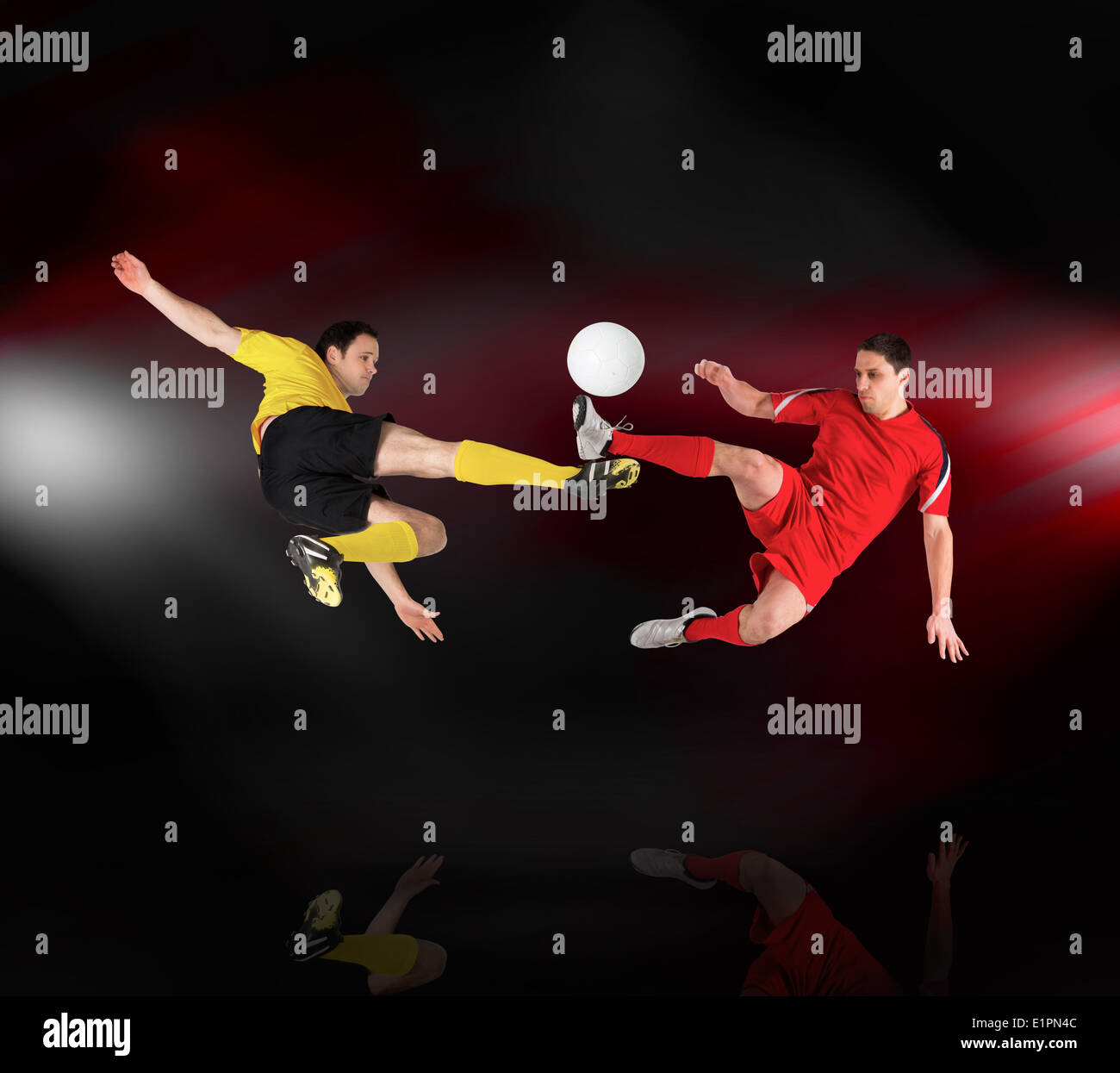 Football players tackling for the ball Stock Photo - Alamy