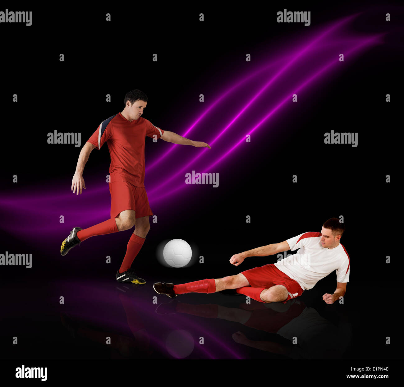 Football players tackling for the ball Stock Photo - Alamy