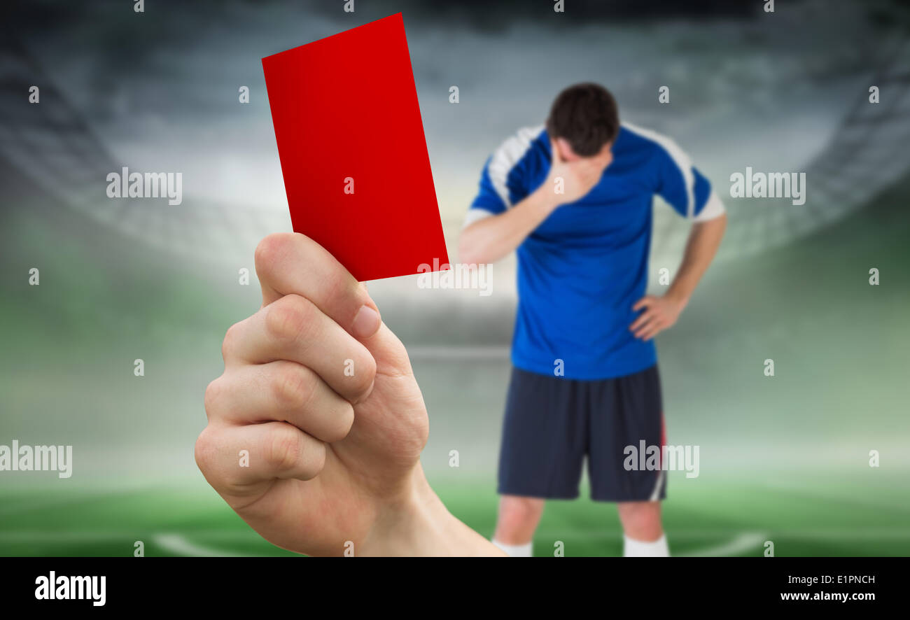 Composite image of hand holding up red card to player Stock Photo - Alamy