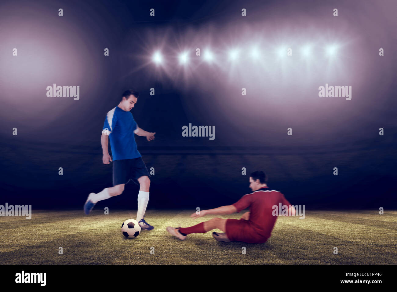 Composite image of football players tackling for the ball Stock Photo ...