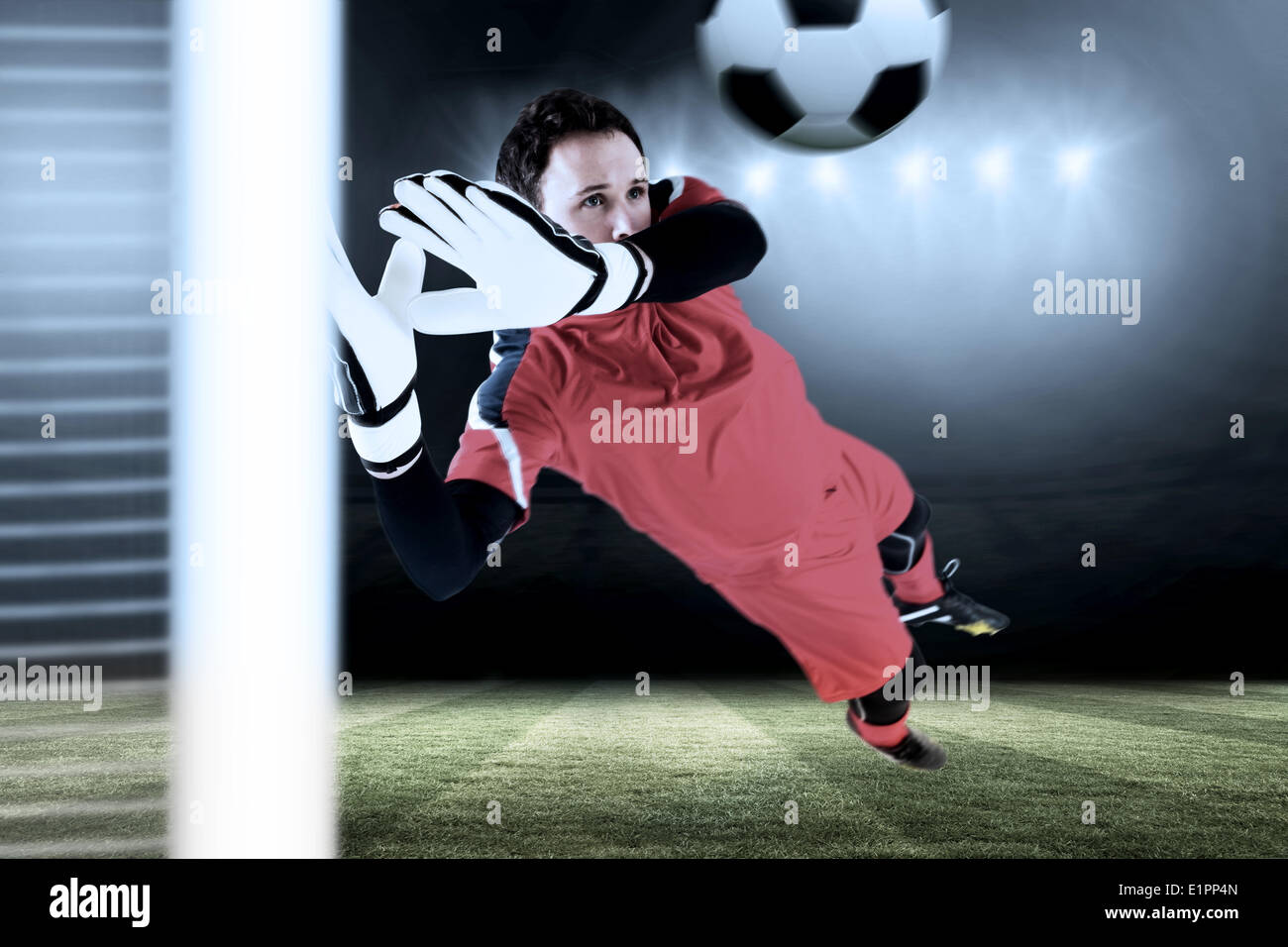 Composite image of fit goal keeper jumping up Stock Photo - Alamy