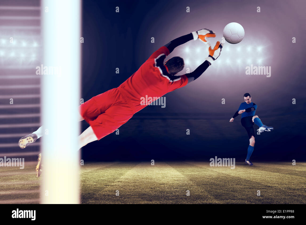 Composite image of goalkeeper in red jumping up Stock Photo - Alamy