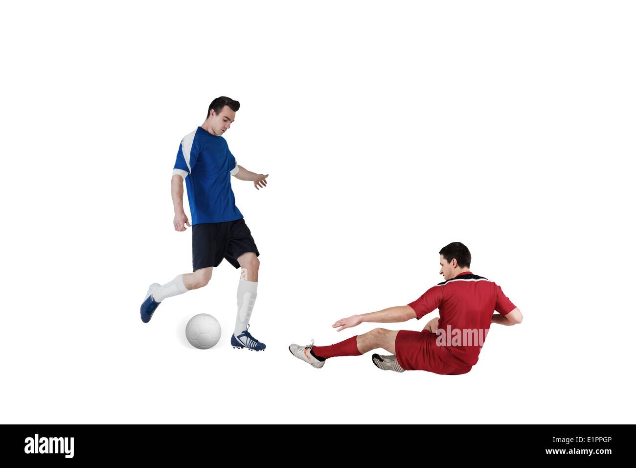 Football players tackling for the ball Stock Photo - Alamy