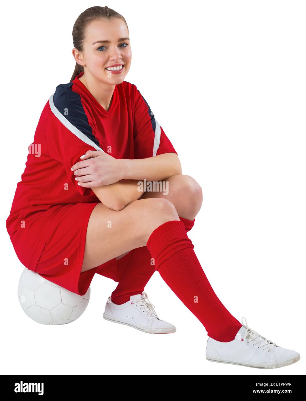 Cute football player sitting with ball Stock Photo - Alamy