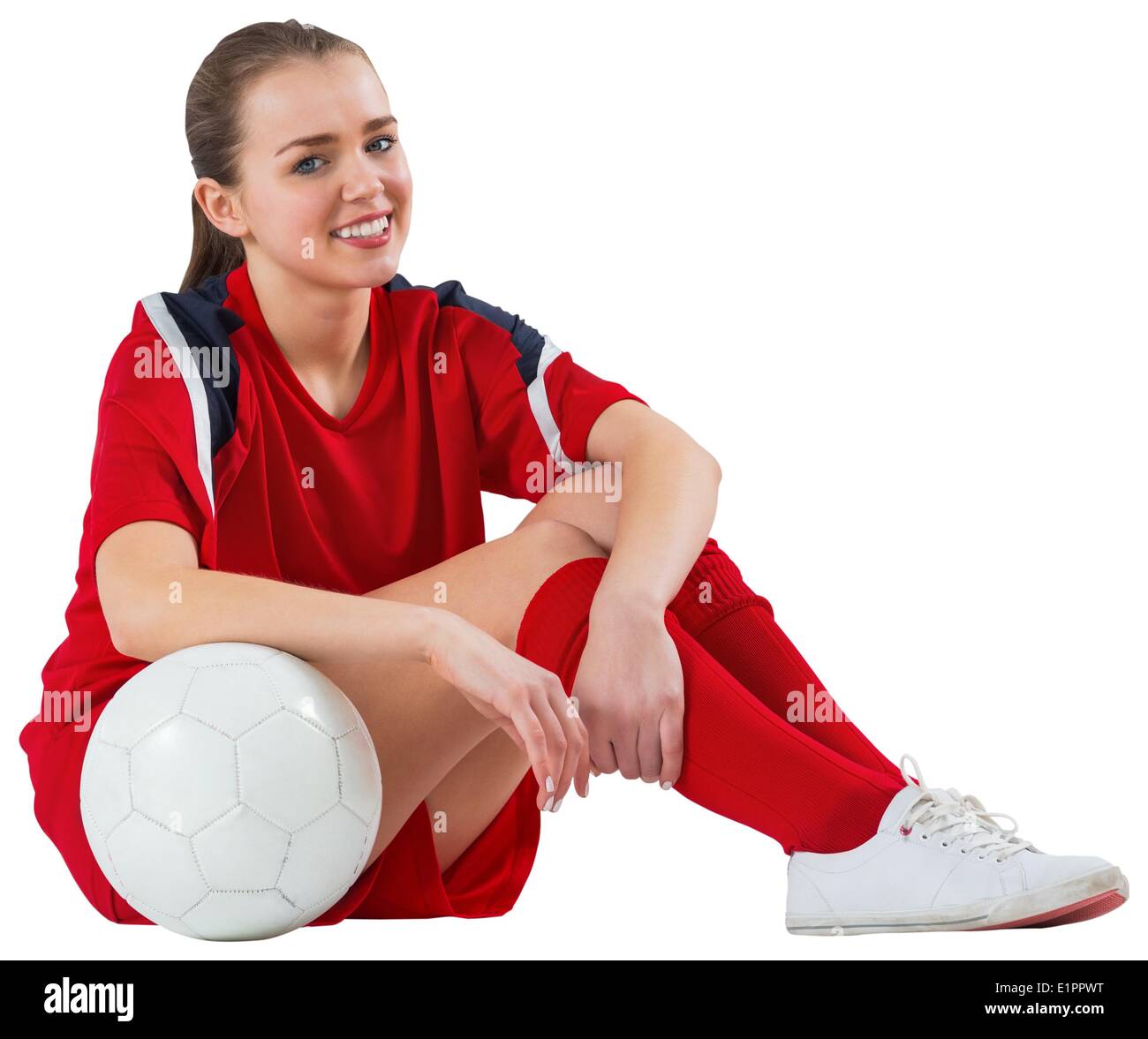 Cute football player sitting with ball Stock Photo - Alamy