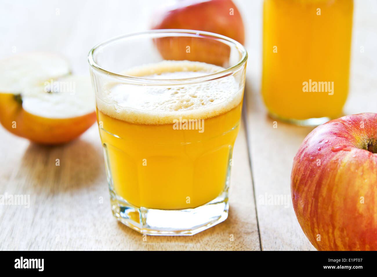 Fresh extract Apple juice by some apples Stock Photo - Alamy