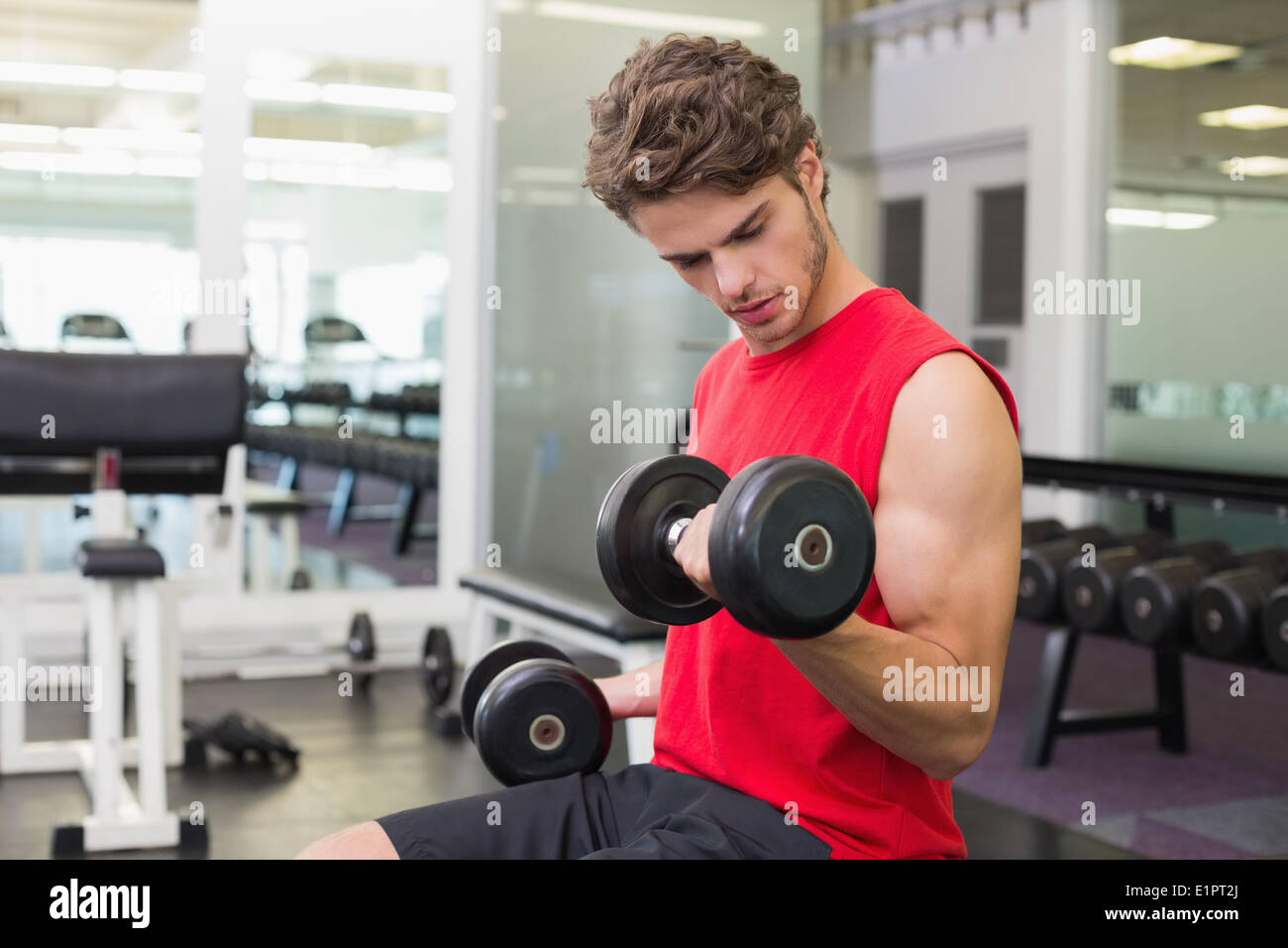 Fit man lifting heavy black dumbbells Stock Photo - Alamy