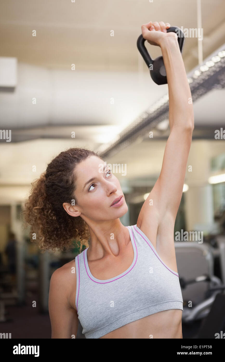 Fit woman lifting up kettlebell Stock Photo - Alamy