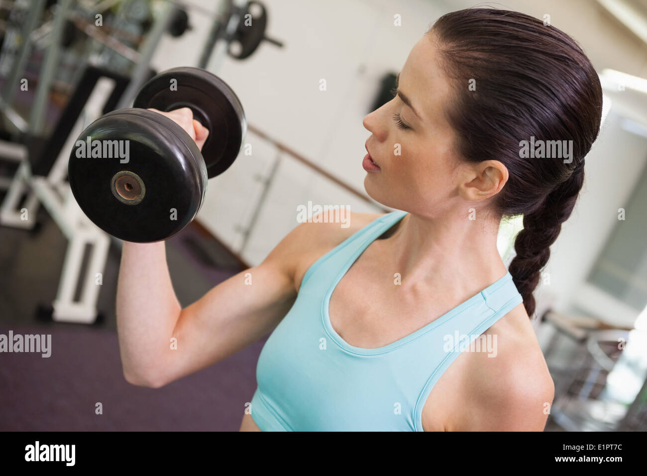Brunette lifting dumbbell hi-res stock photography and images - Alamy