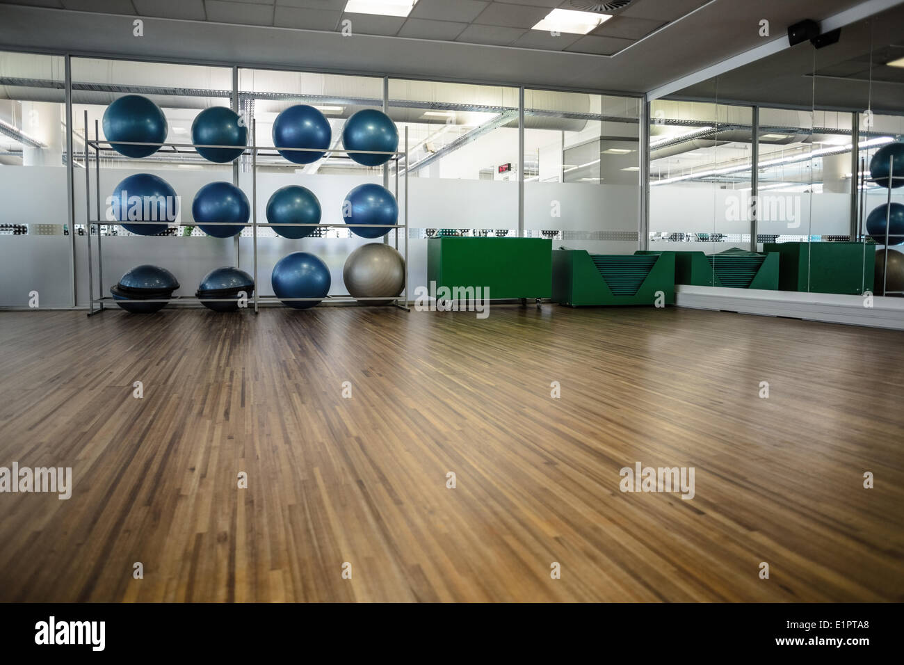 Large empty fitness studio with shelf of exercise balls Stock Photo - Alamy