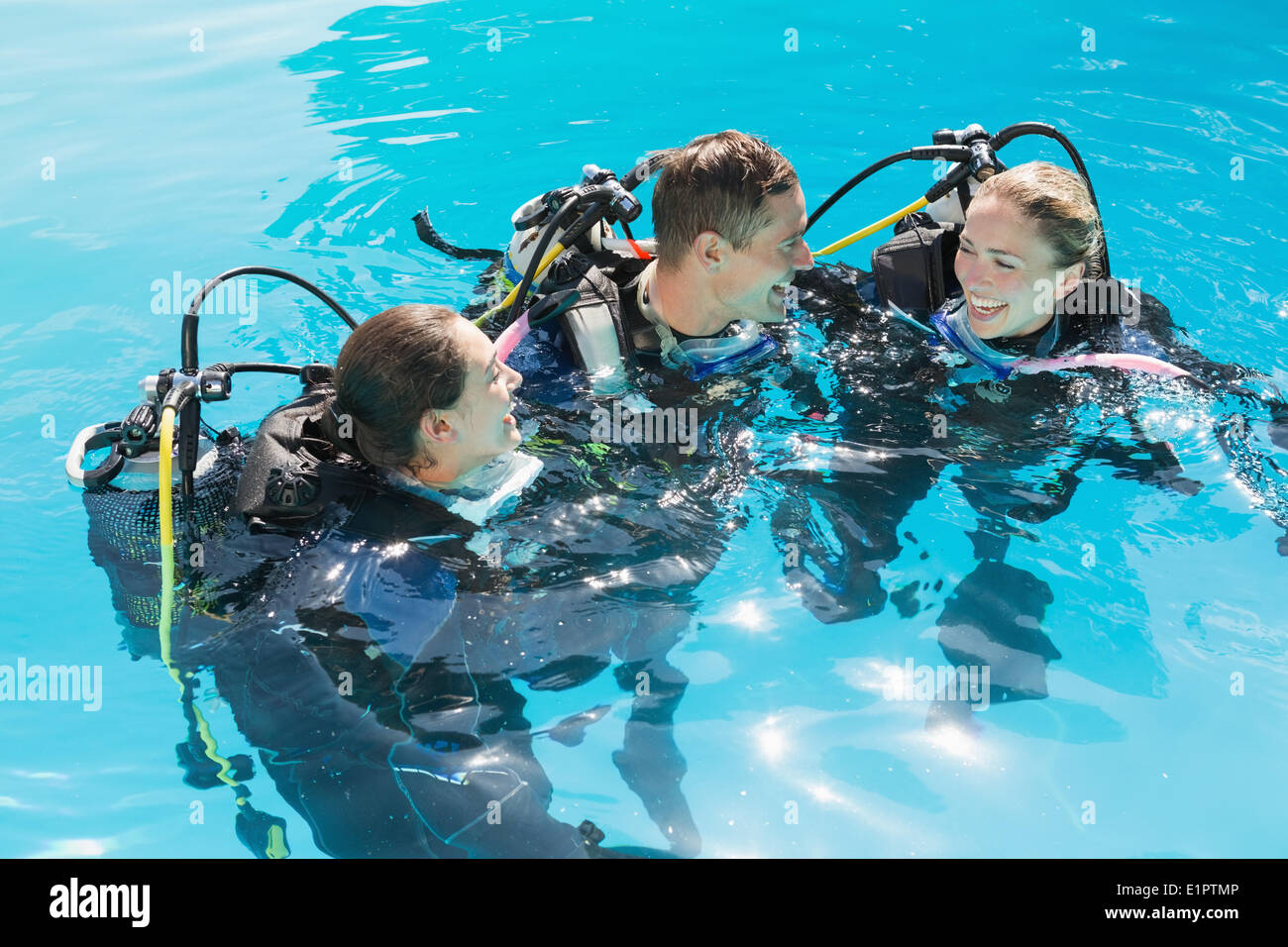 Smiling friends on scuba training in swimming pool Stock Photo - Alamy