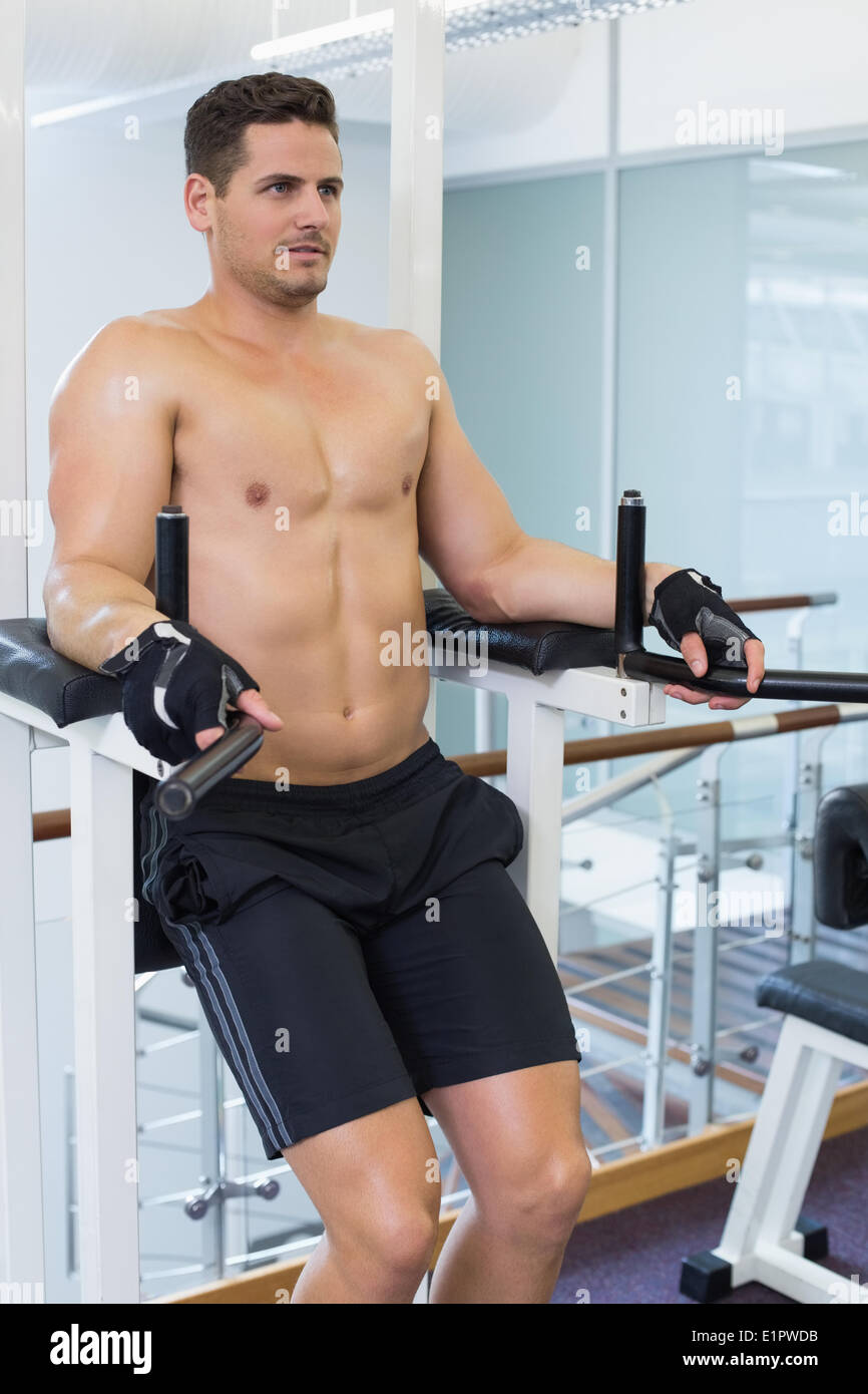 Shirtless bodybuilder doing leg lifts Stock Photo - Alamy