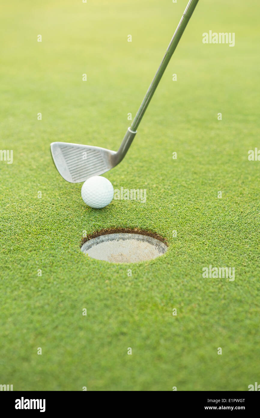 Golf club putting ball at the hole Stock Photo - Alamy