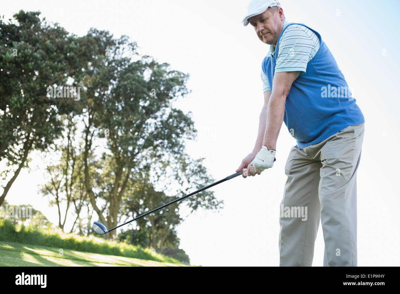 Golfer holding his golf club Stock Photo - Alamy