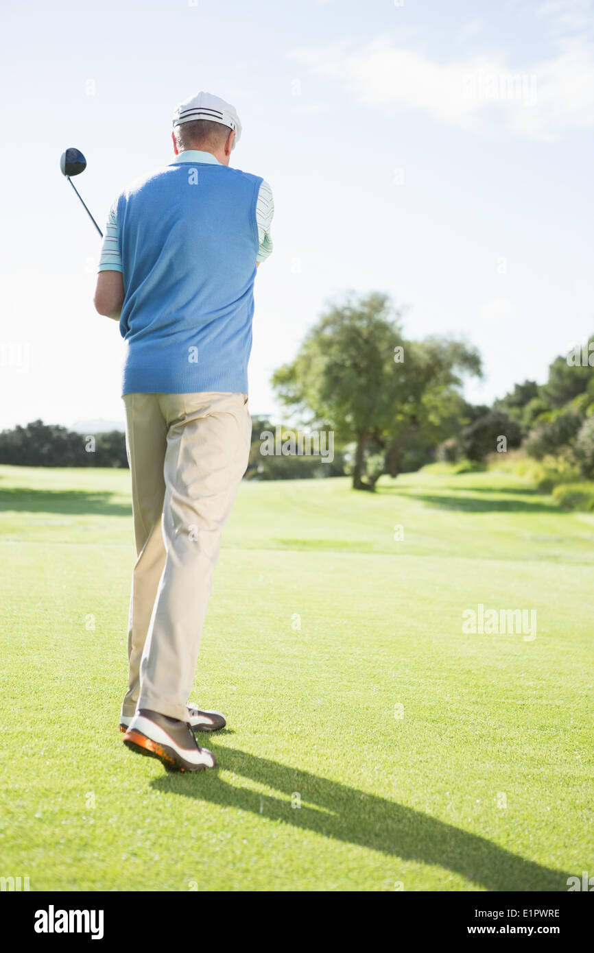 Golf player taking a shot Stock Photo - Alamy