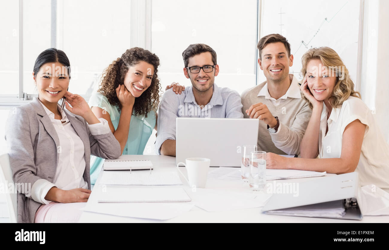 Casual business team smiling at camera during meeting Stock Photo - Alamy