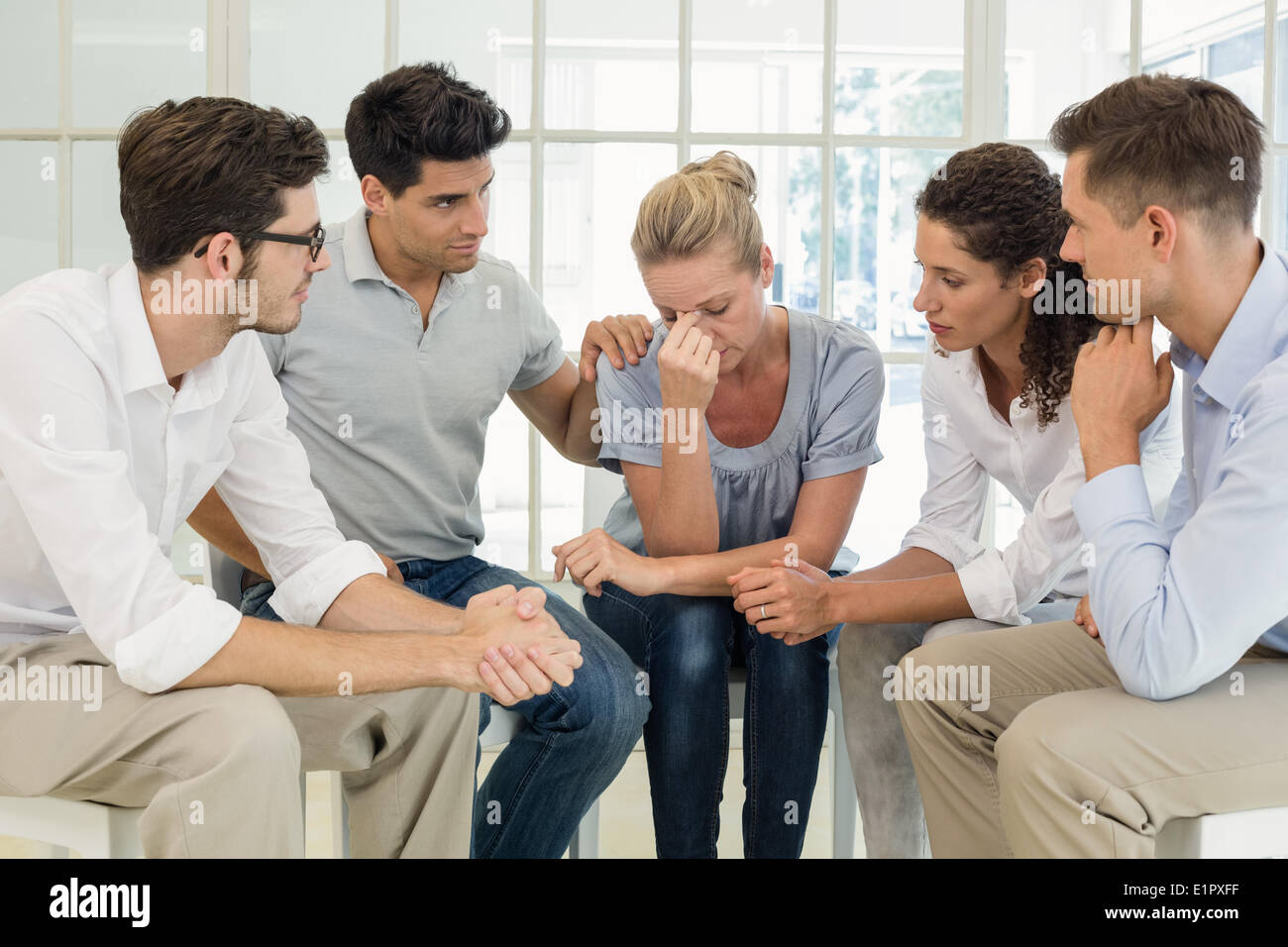 Group therapy in session sitting in a circle Stock Photo - Alamy