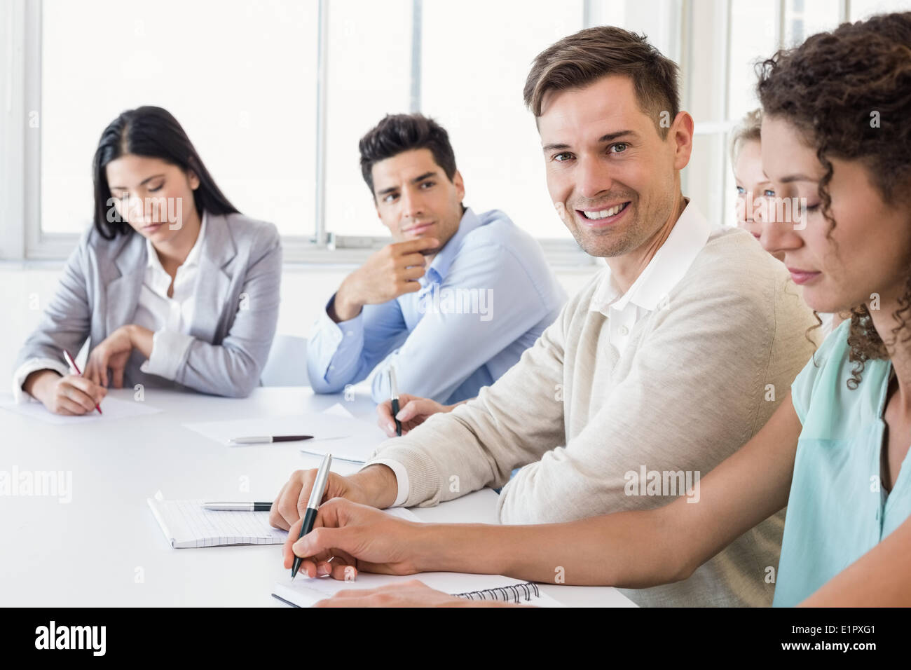 Attentive smiling businessman listening hi-res stock photography and ...
