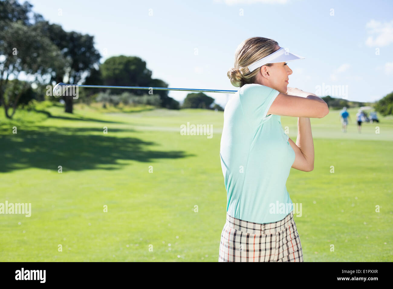 Lady golfer teeing off for the day Stock Photo - Alamy