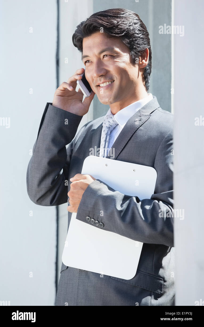 Estate agent talking on phone Stock Photo - Alamy