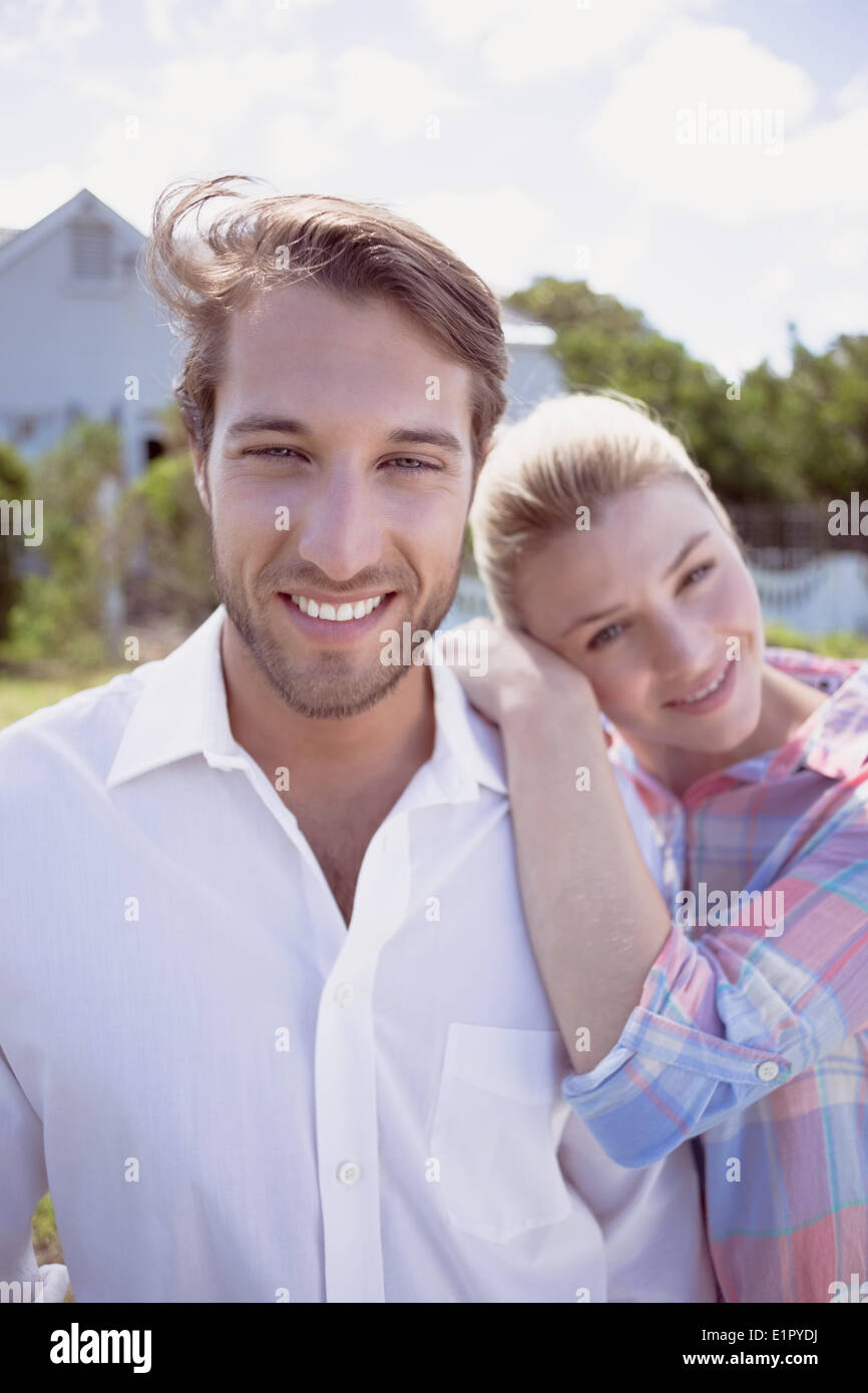 Happy couple smiling at camera Stock Photo - Alamy