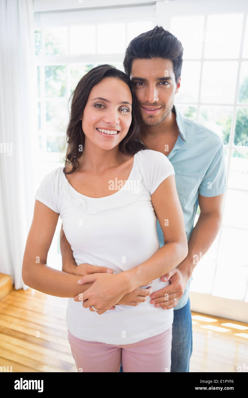 Attractive couple standing and hugging Stock Photo - Alamy