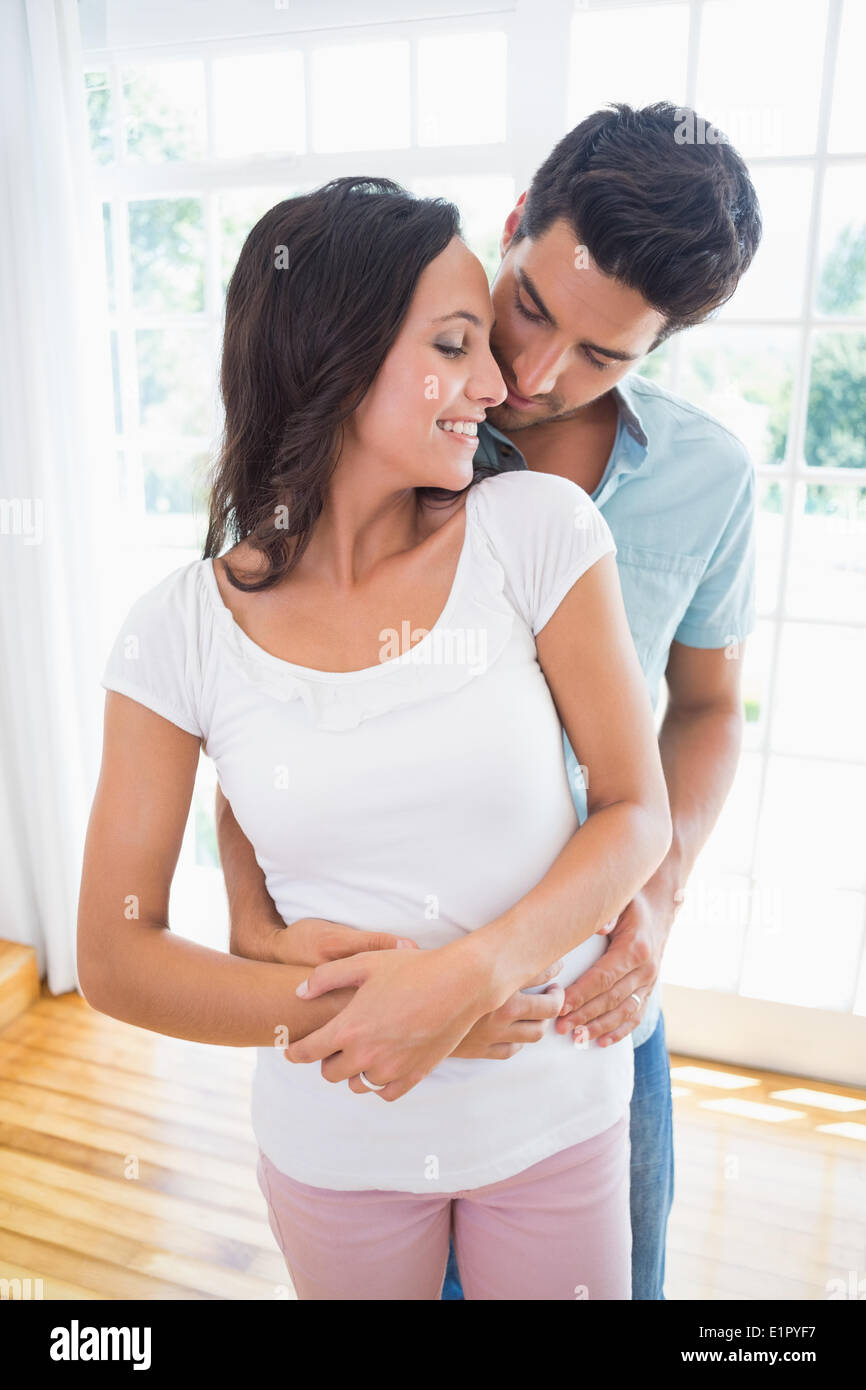 Attractive couple standing and hugging Stock Photo - Alamy