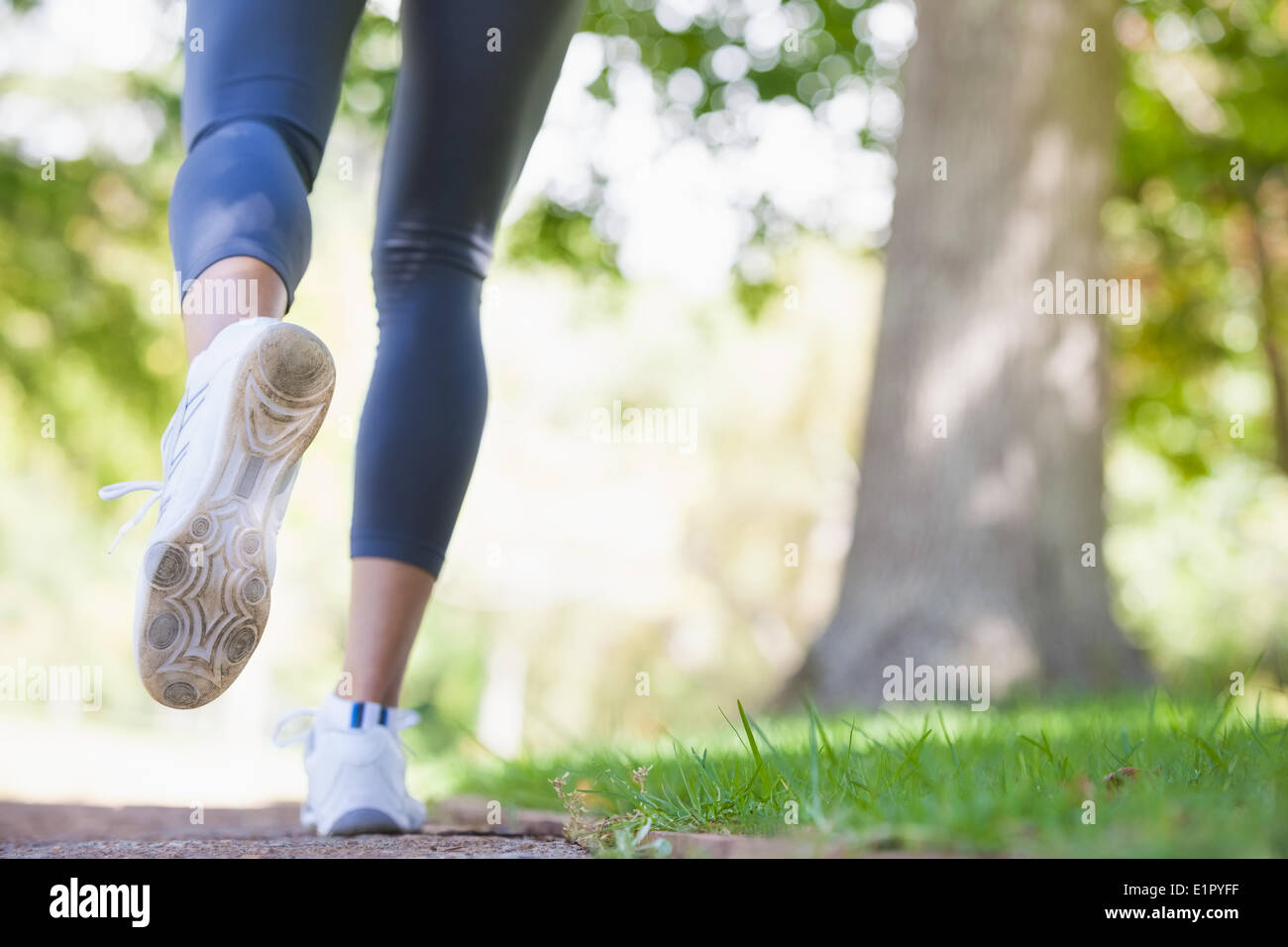 Woman jogging on path in the park Stock Photo - Alamy