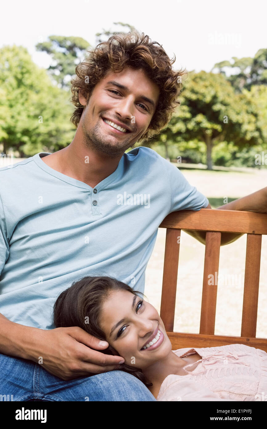Cute couple relaxing on park bench Stock Photo - Alamy