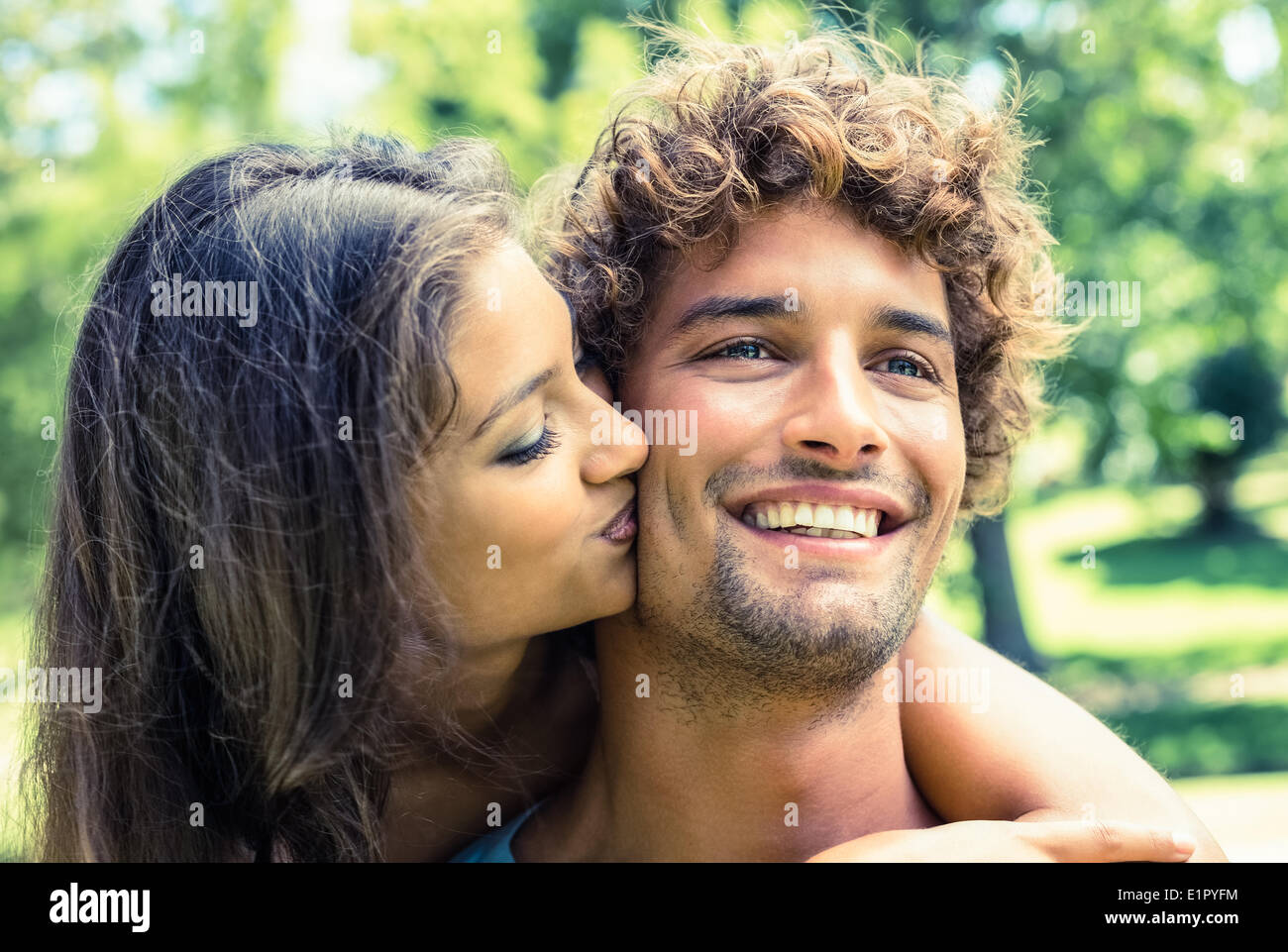 Cute couple relaxing on park bench Stock Photo - Alamy