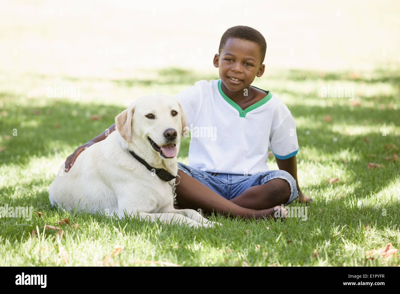 Cute little boy sitting with labrador dog Stock Photo - Alamy