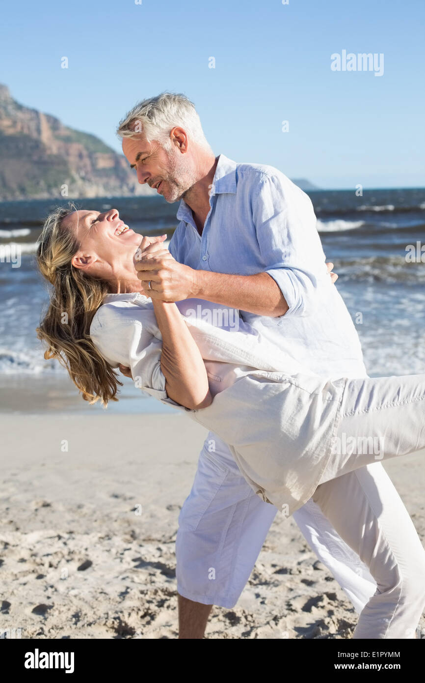 Carefree woman dancing on beach hi-res stock photography and images - Alamy