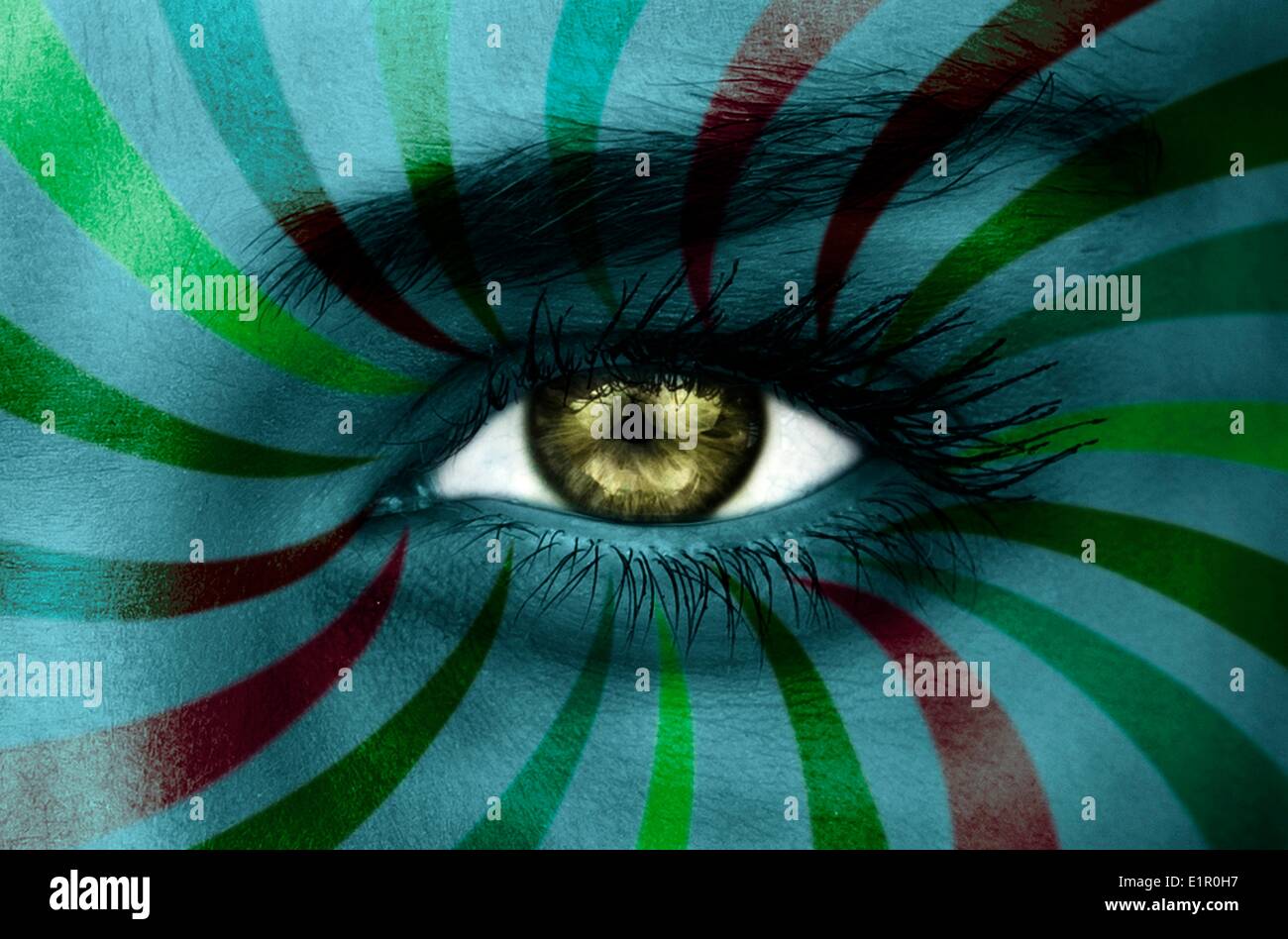 Green eye on patterned face Stock Photo - Alamy