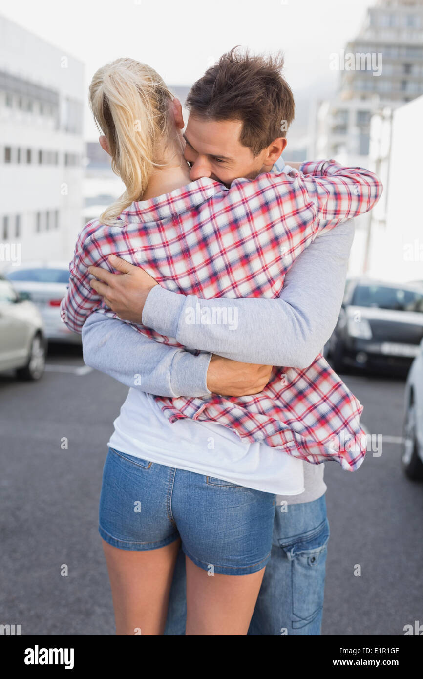 Hip young couple hugging each other Stock Photo - Alamy