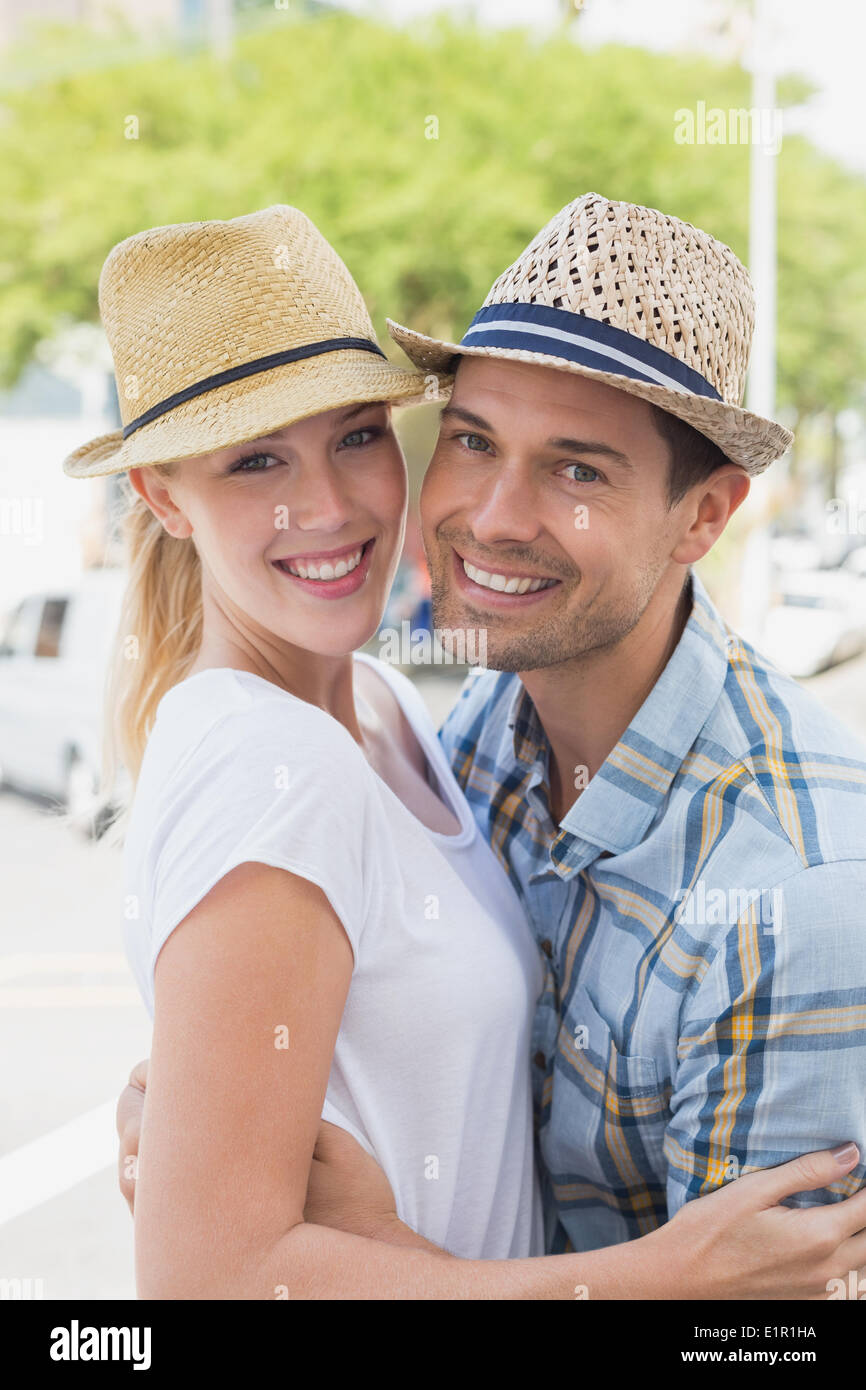 Young hip couple hugging and smiling at camera Stock Photo - Alamy
