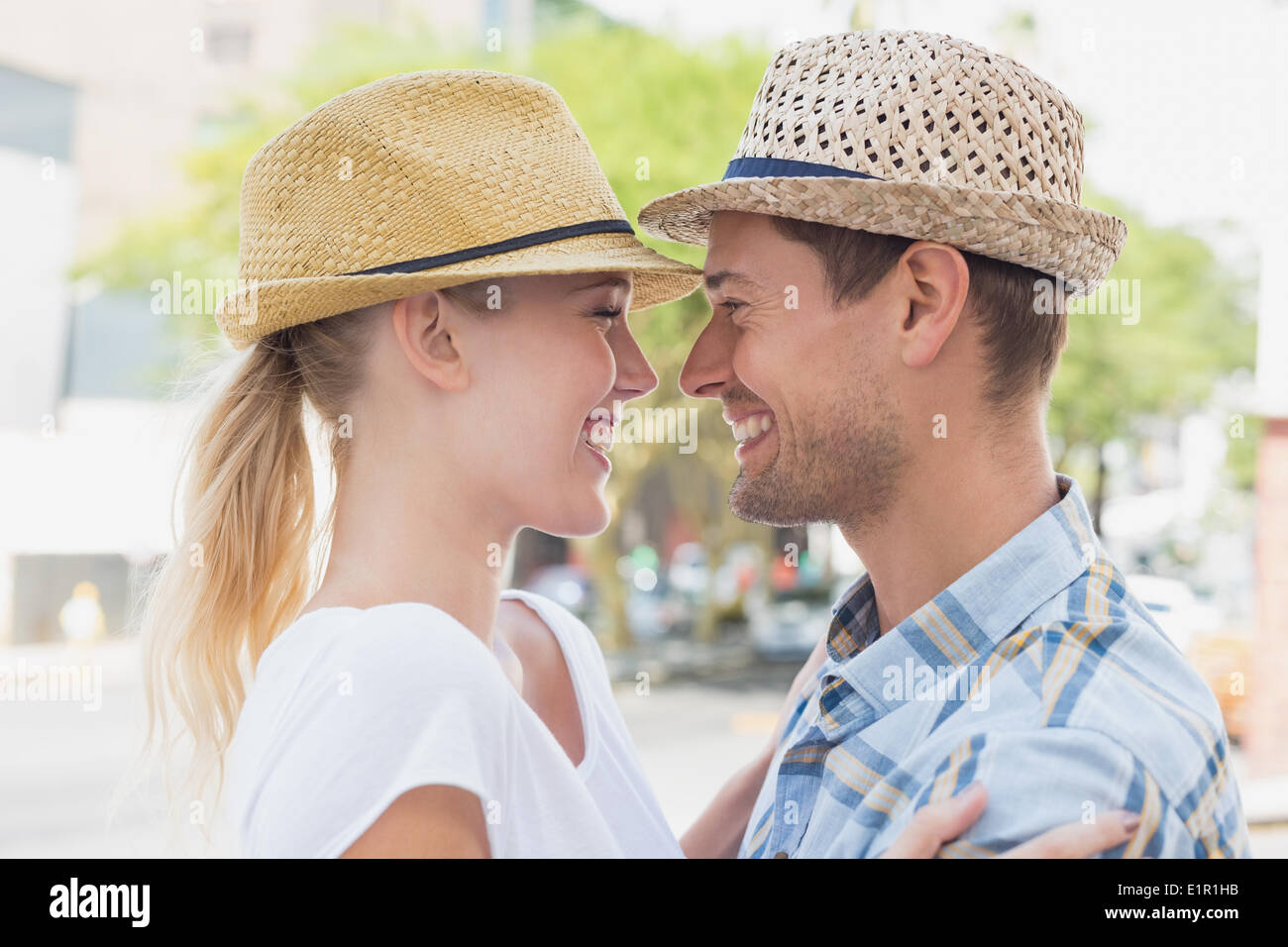 Young hip couple hugging and smiling at each other Stock Photo - Alamy