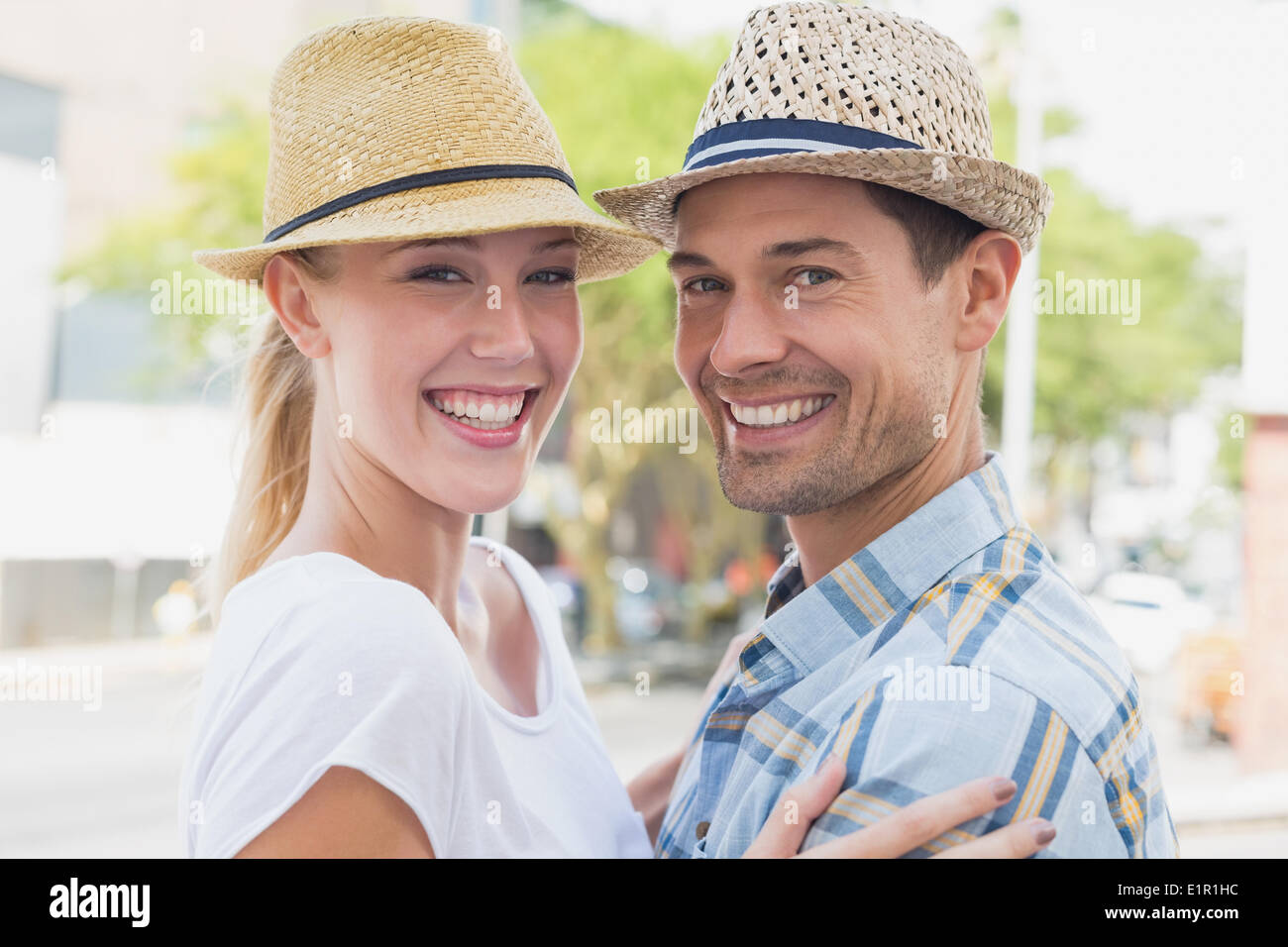 Young hip couple hugging and smiling at camera Stock Photo - Alamy
