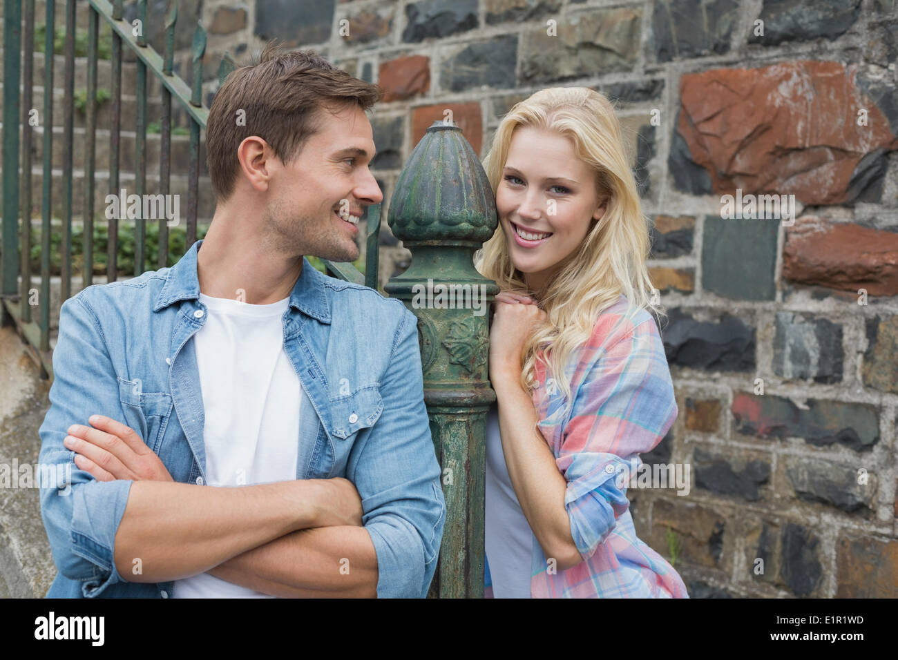 Hip young couple standing by steps Stock Photo - Alamy