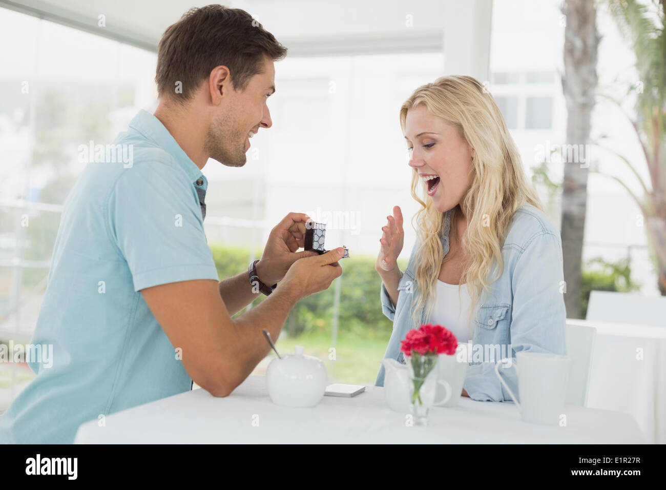 Man proposing marriage to his shocked blonde girlfriend Stock Photo - Alamy