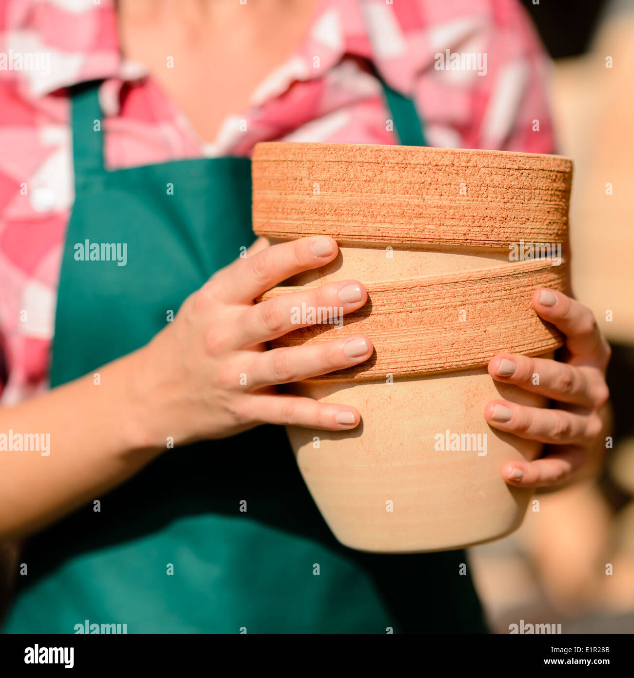 Close-up of garden center worker hands holding two clay pots Stock ...