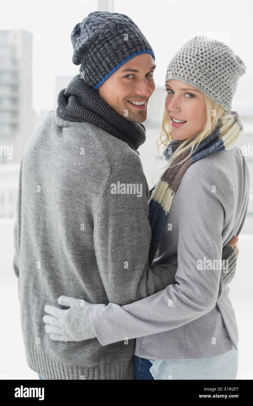 Cute couple in warm clothing hugging smiling at camera Stock Photo - Alamy