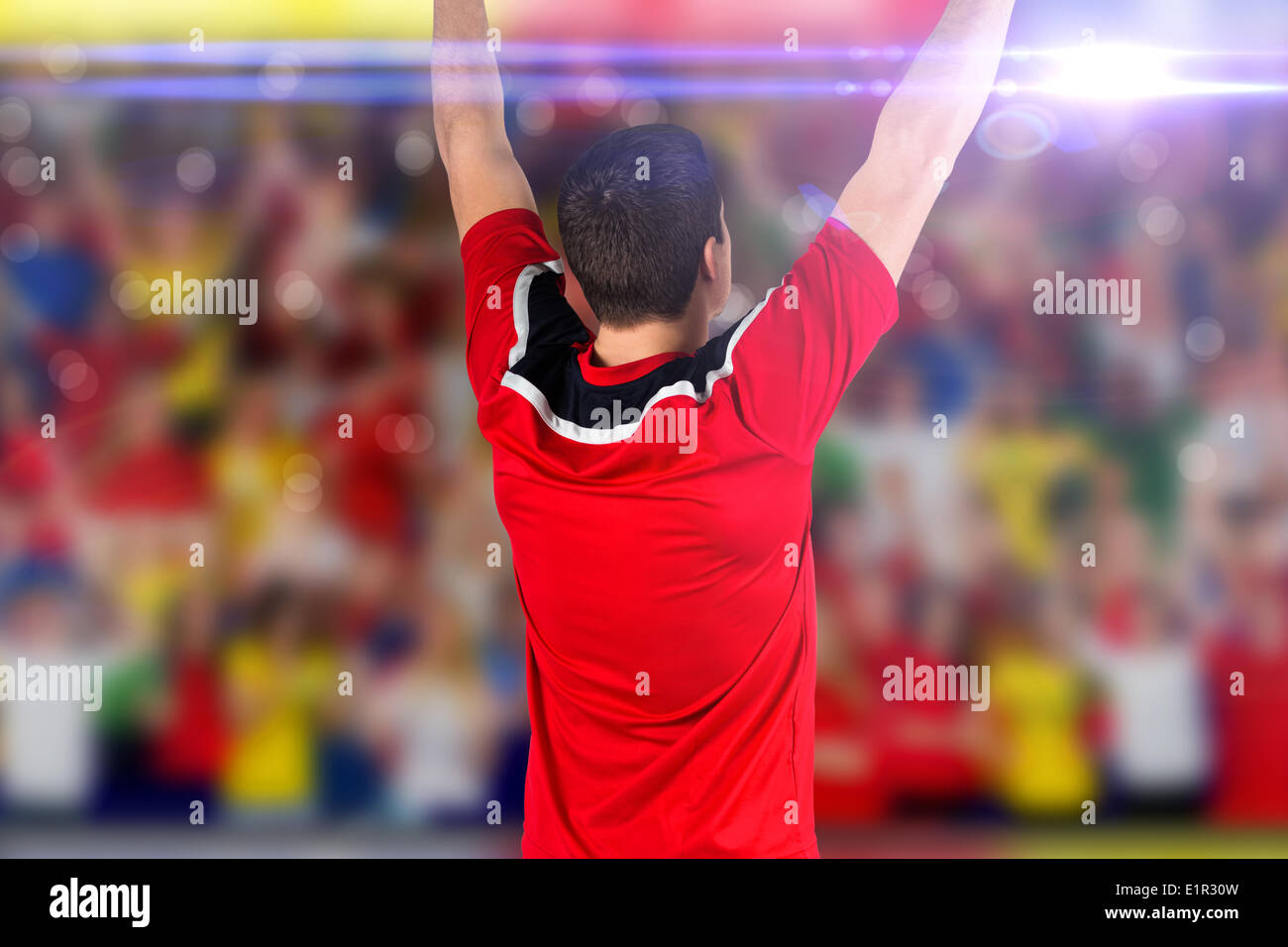 Composite image of excited football player cheering Stock Photo - Alamy