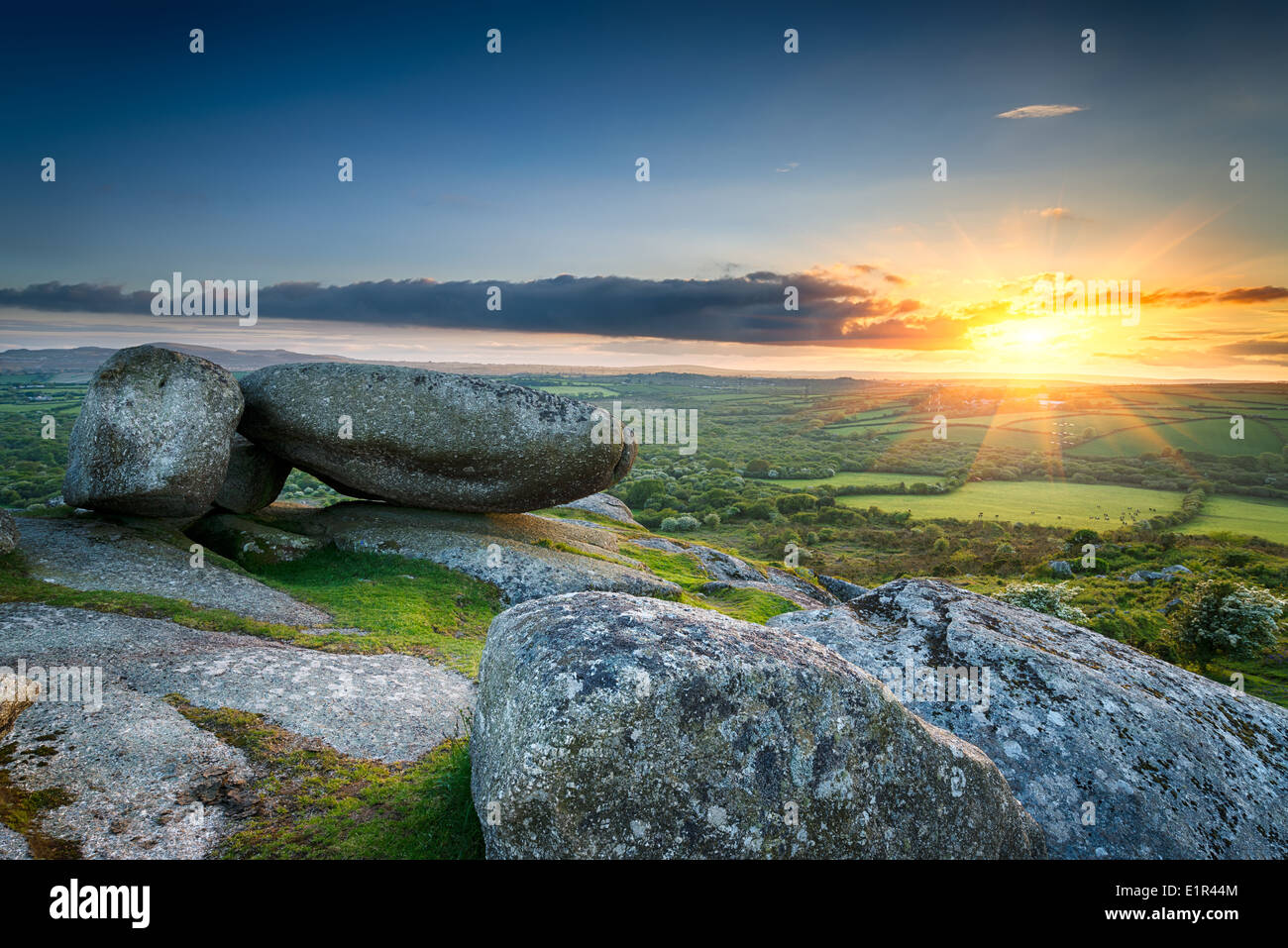 Sunset over giant granite boulders at Helman Tor a rugged area of moor ...