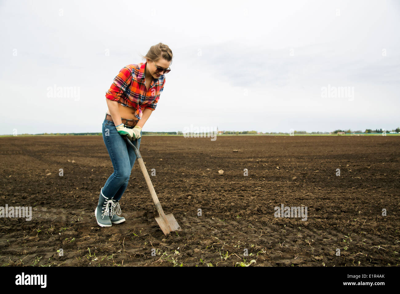 Young woman with sharp shovel try dig ground Stock Photo - Alamy