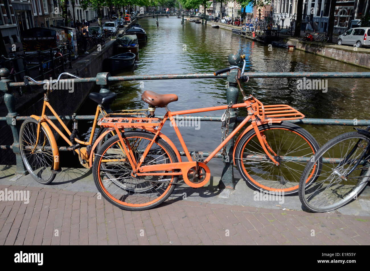 Orange bikes on canal bridge in central Amsterdam Holland Stock Photo ...