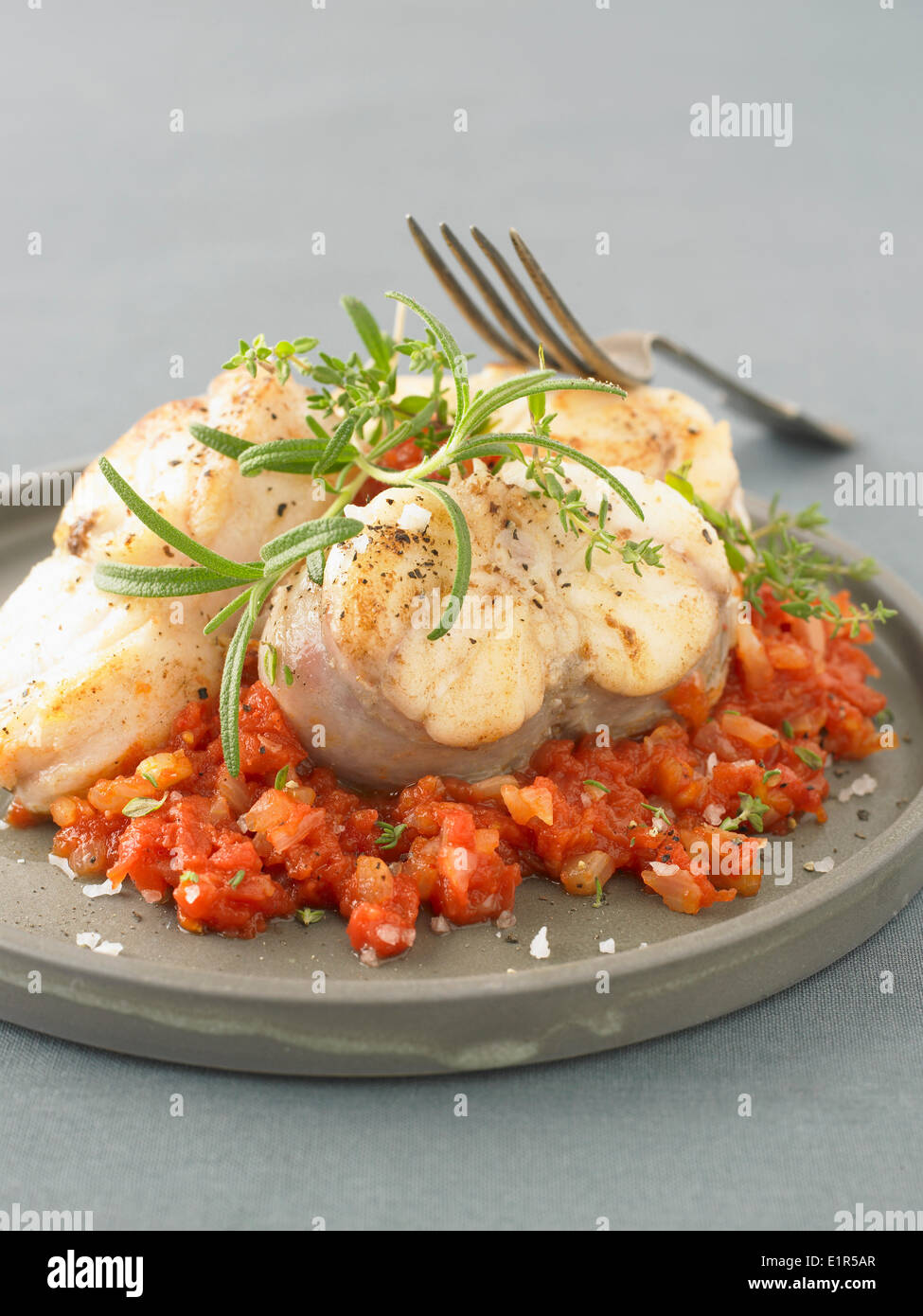 Monkfish with tomatoes Stock Photo - Alamy