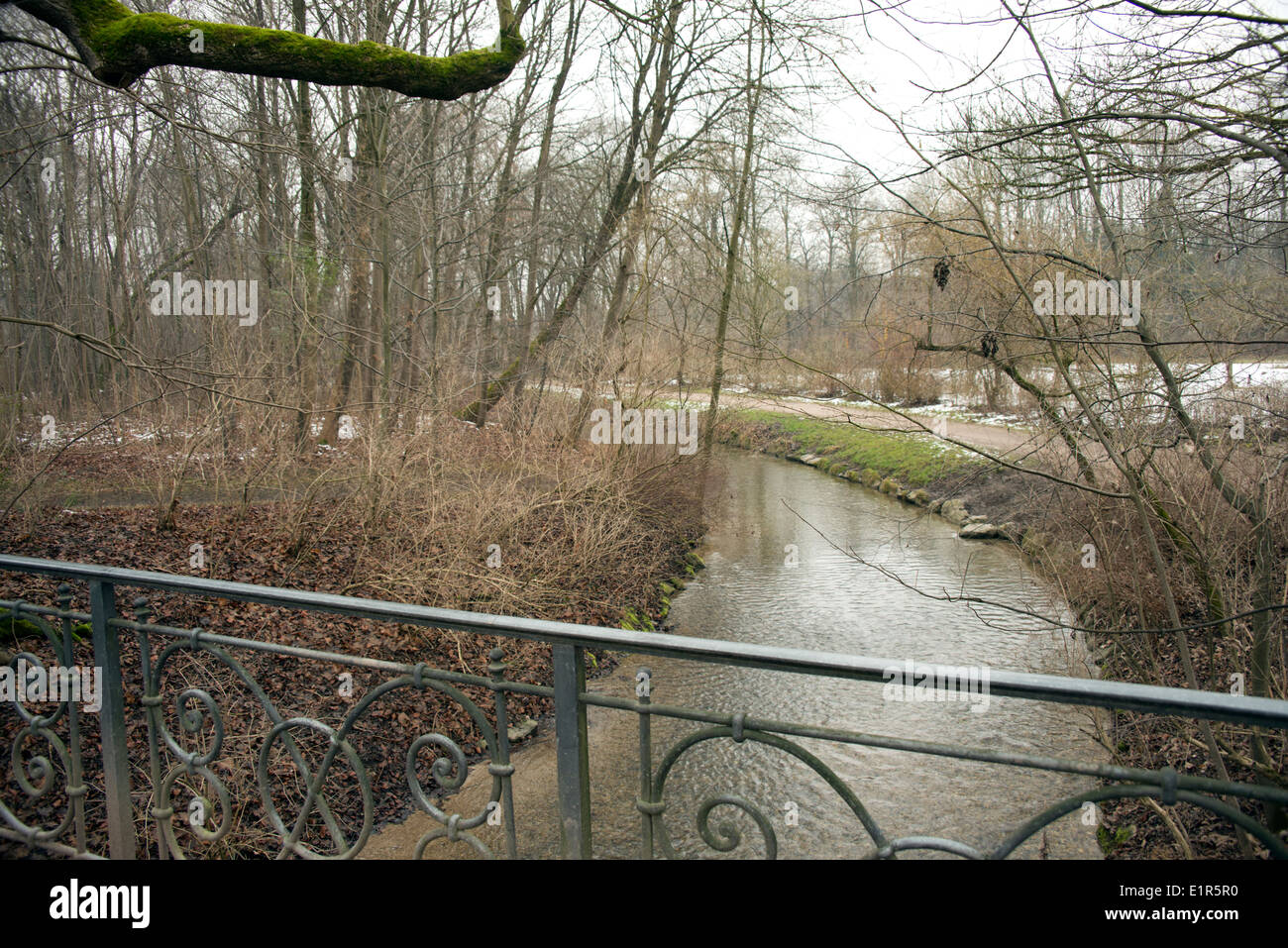 Wrought-iron bridge railing over a stream in winter Stock Photo - Alamy