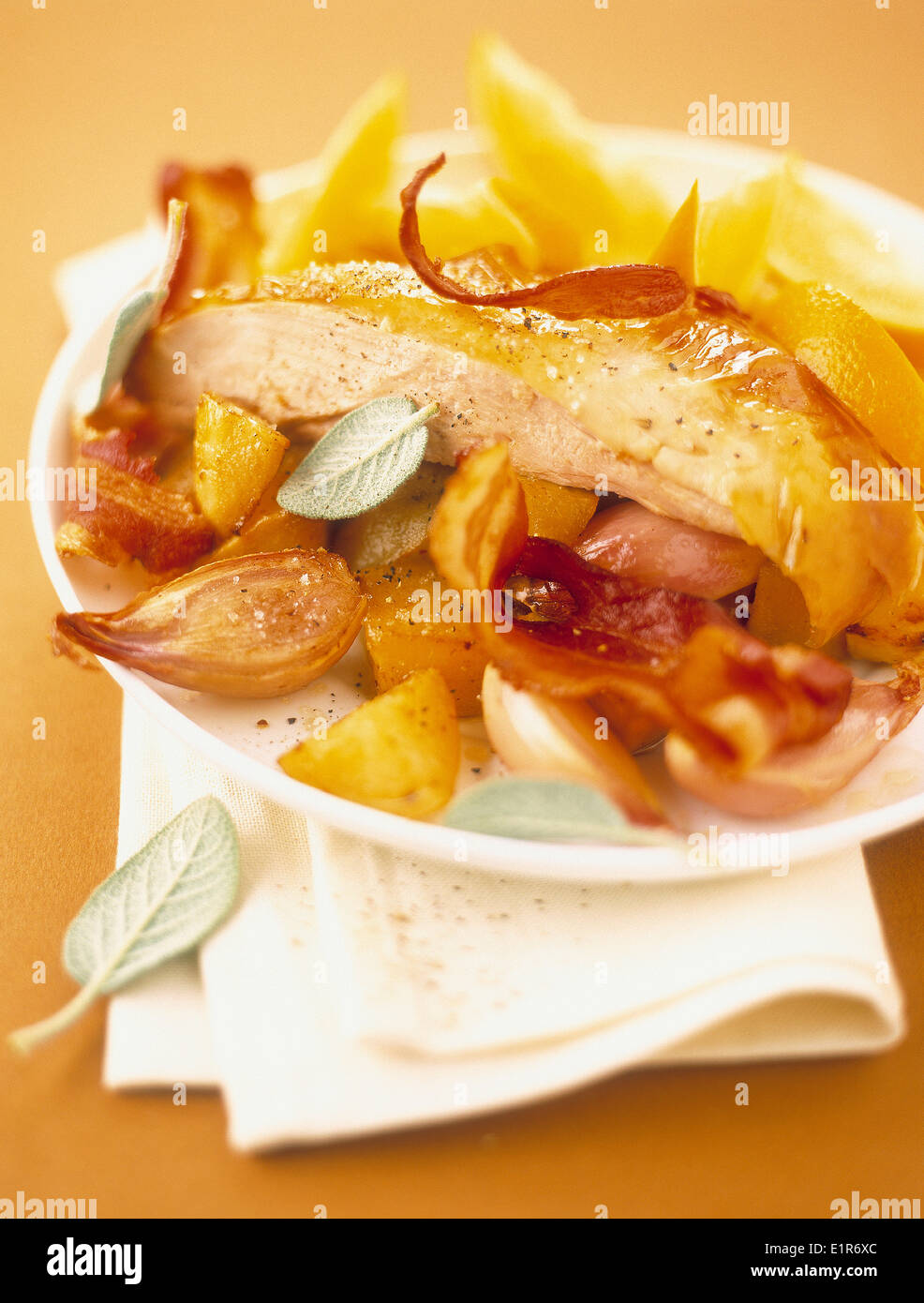 Guinea fowl with orange, fried potatoes, garlic and bacon Stock Photo ...
